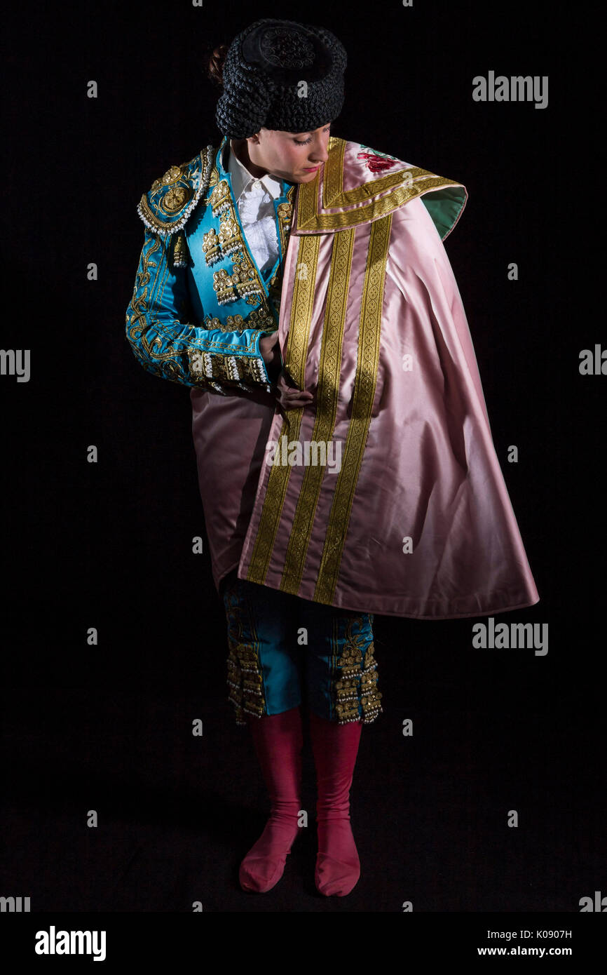 Woman bullfighter by dressing with vest on your back on a black ...