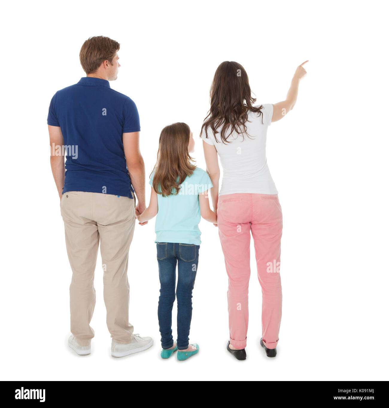Full length rear view of woman showing something to family over white ...