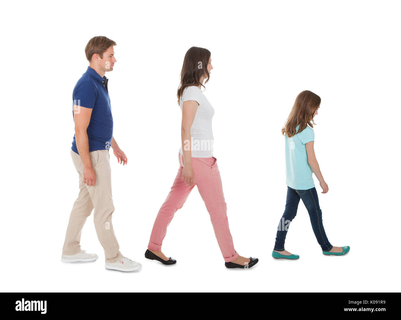 Full length side view of family walking in a row isolated over white ...