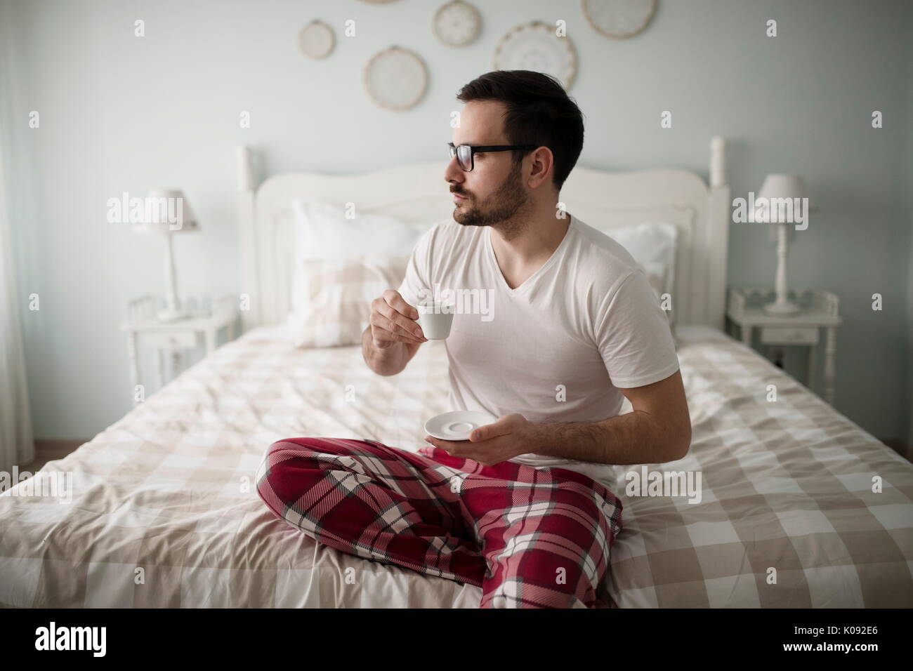 Portrait of handsome young man drinking coffee Stock Photo - Alamy