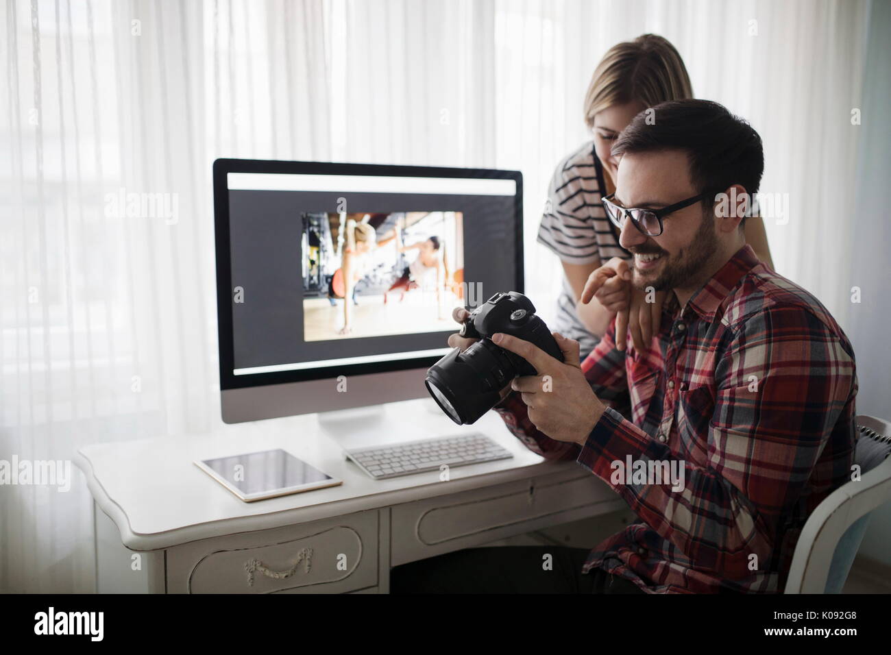 Beautiful woman and attractive man doing design work Stock Photo - Alamy