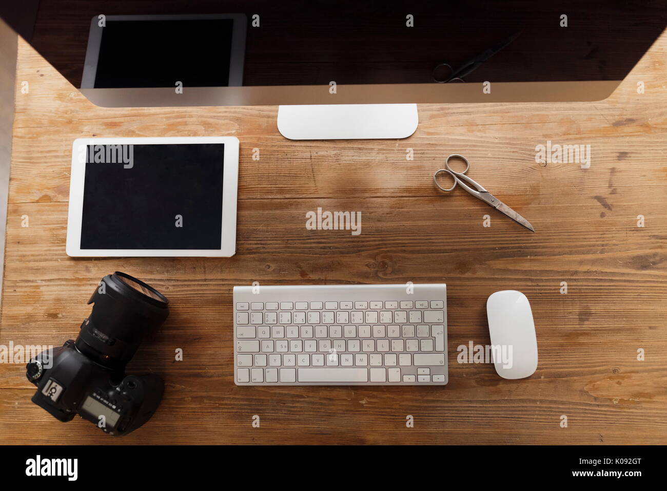 Picture of computer, scissors and camera on working desk Stock Photo ...