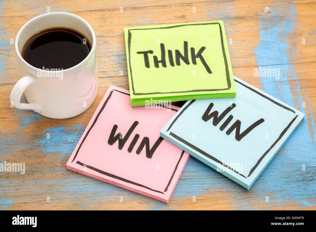 Think win-win concept - handwriting on sticky notes against grunge wood ...