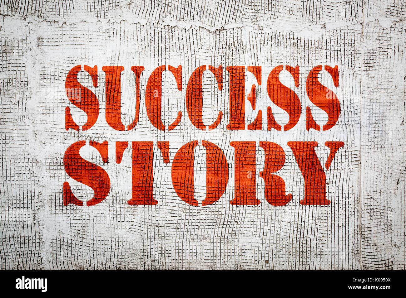 success story sign painted in stencil font on an old, grunge stucco ...