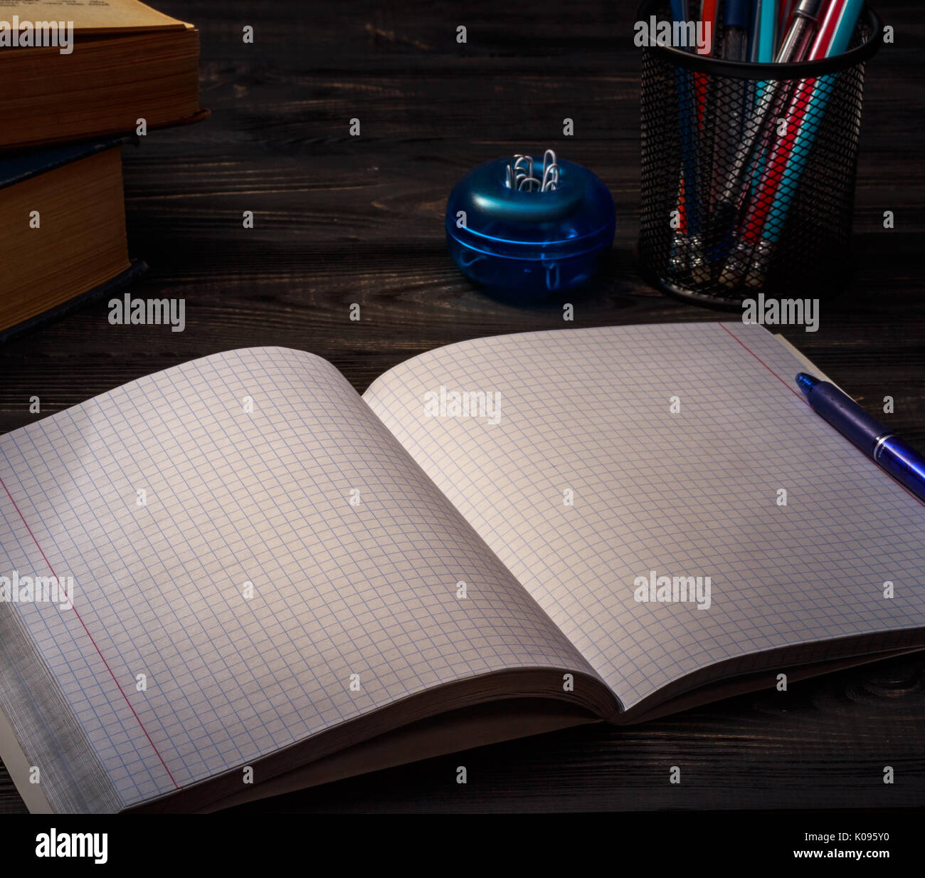 Busy student's desk with open notebook Stock Photo - Alamy