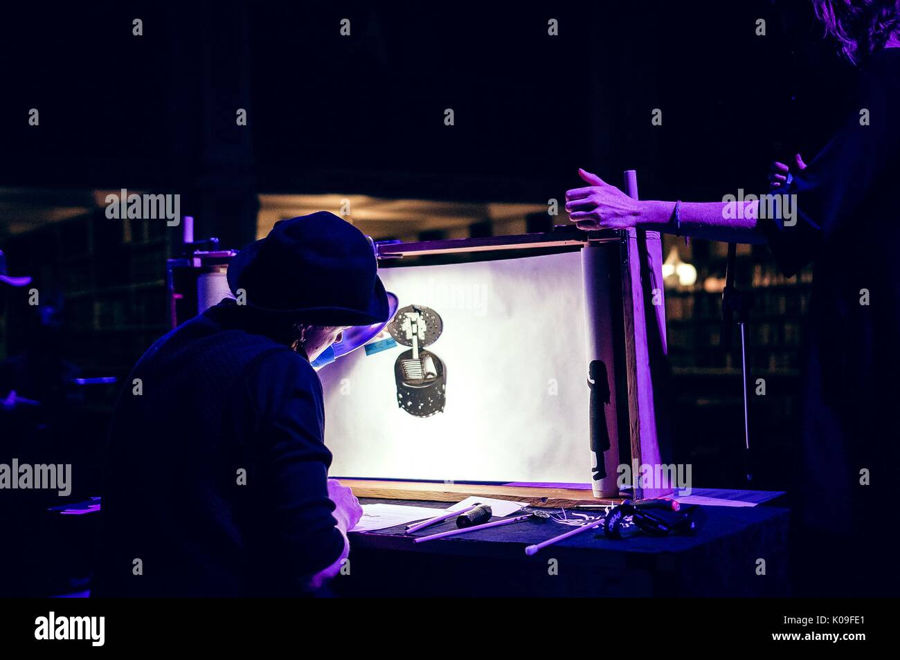 Shadow puppet show behind screen hi-res stock photography and images ...