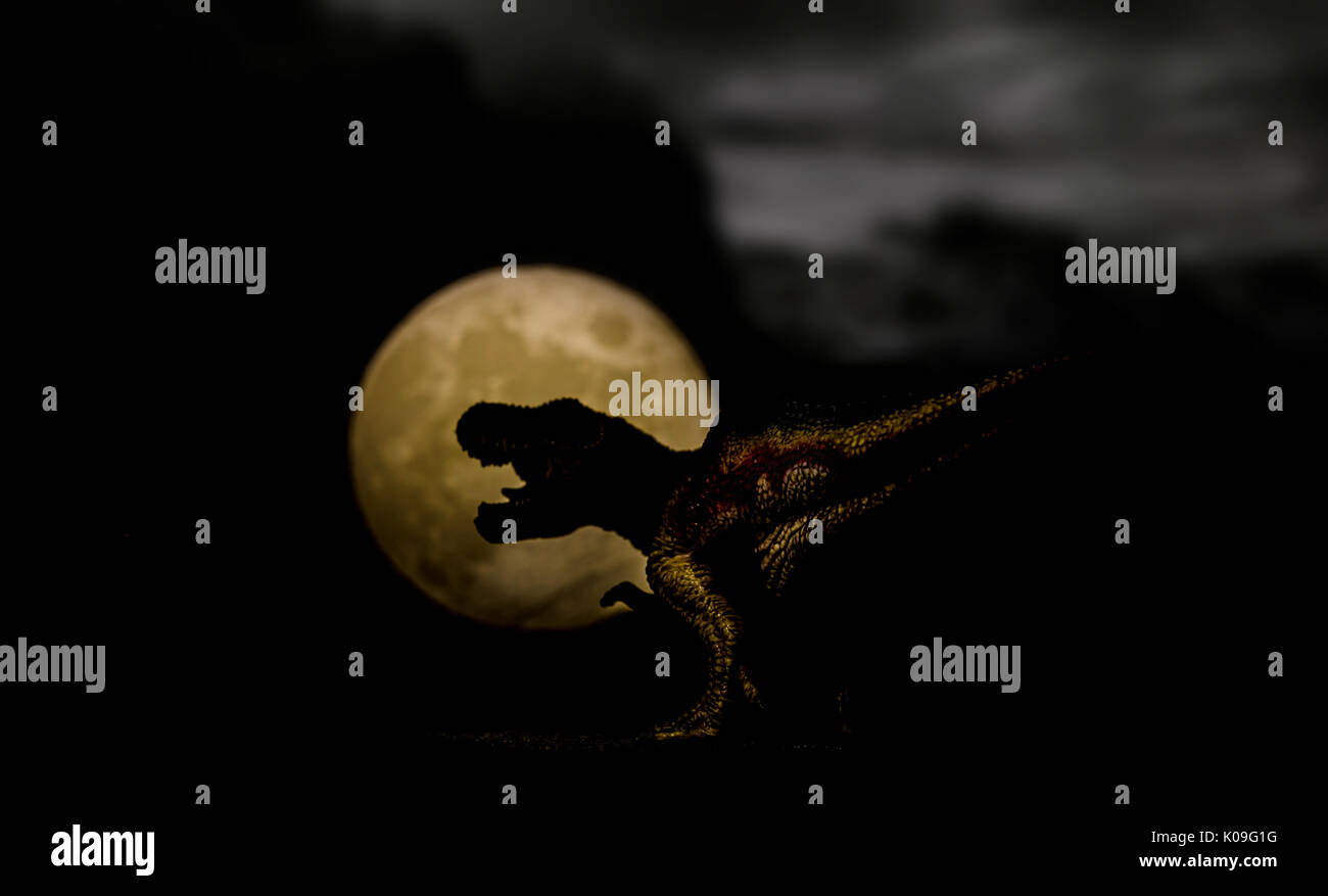 dinosaur with full moon, silhouette on dark night Stock Photo - Alamy