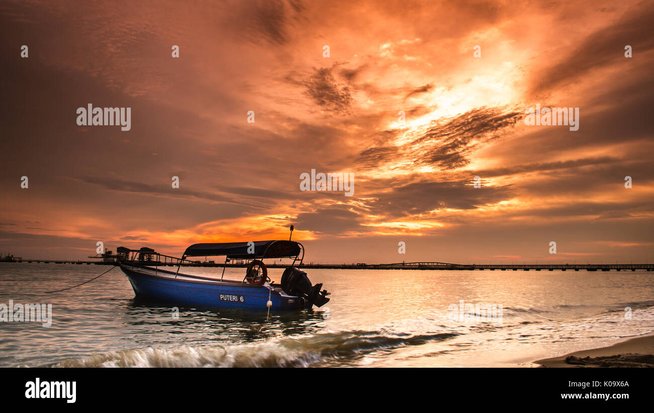 Boat stranded on a beach after spent a day at the sea Stock Photo - Alamy
