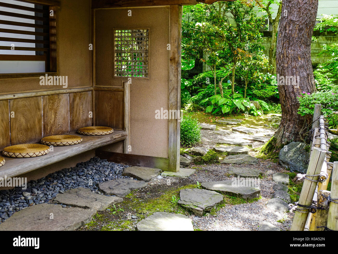 Japanese garden with wooden relaxing house and green trees in summer ...