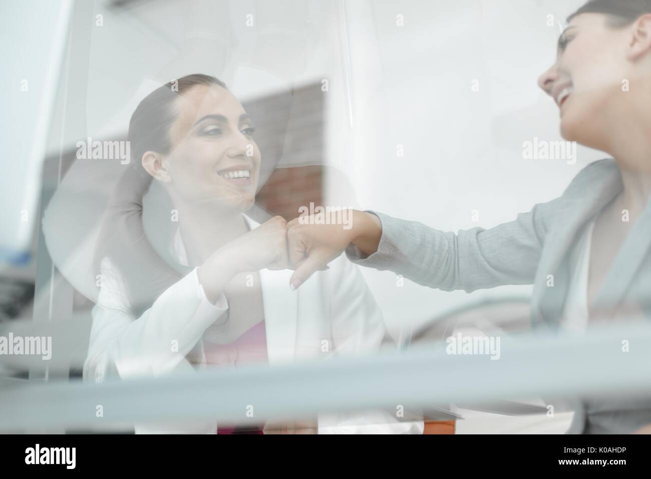 behind the glass.colleagues celebrate their success Stock Photo - Alamy