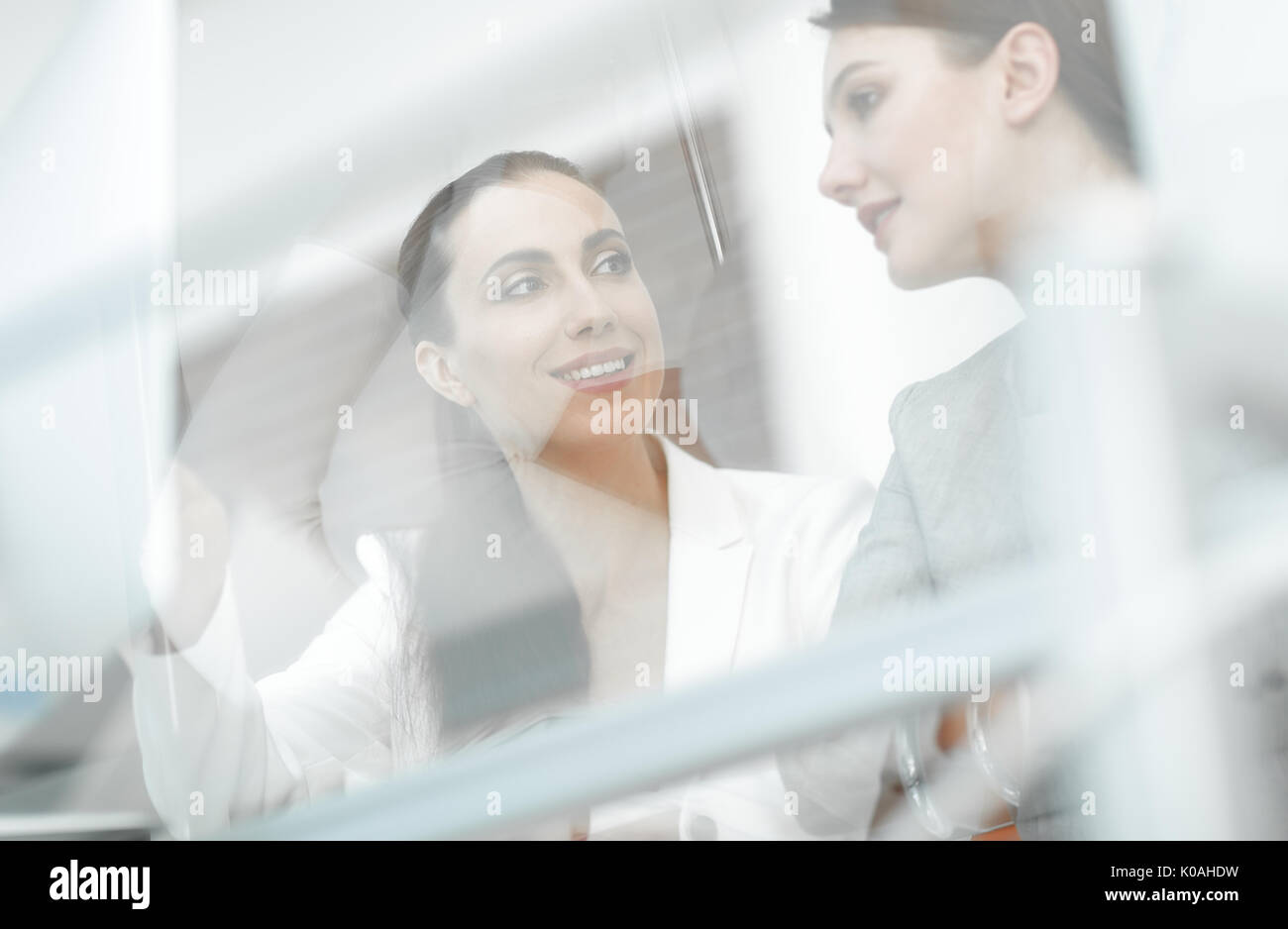 behind the glass.colleagues sitting at your Desk Stock Photo - Alamy