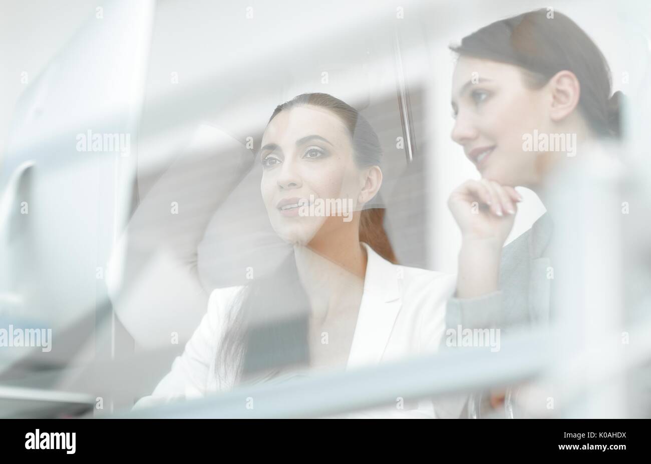 behind the glass.business team sitting at Desk Stock Photo - Alamy