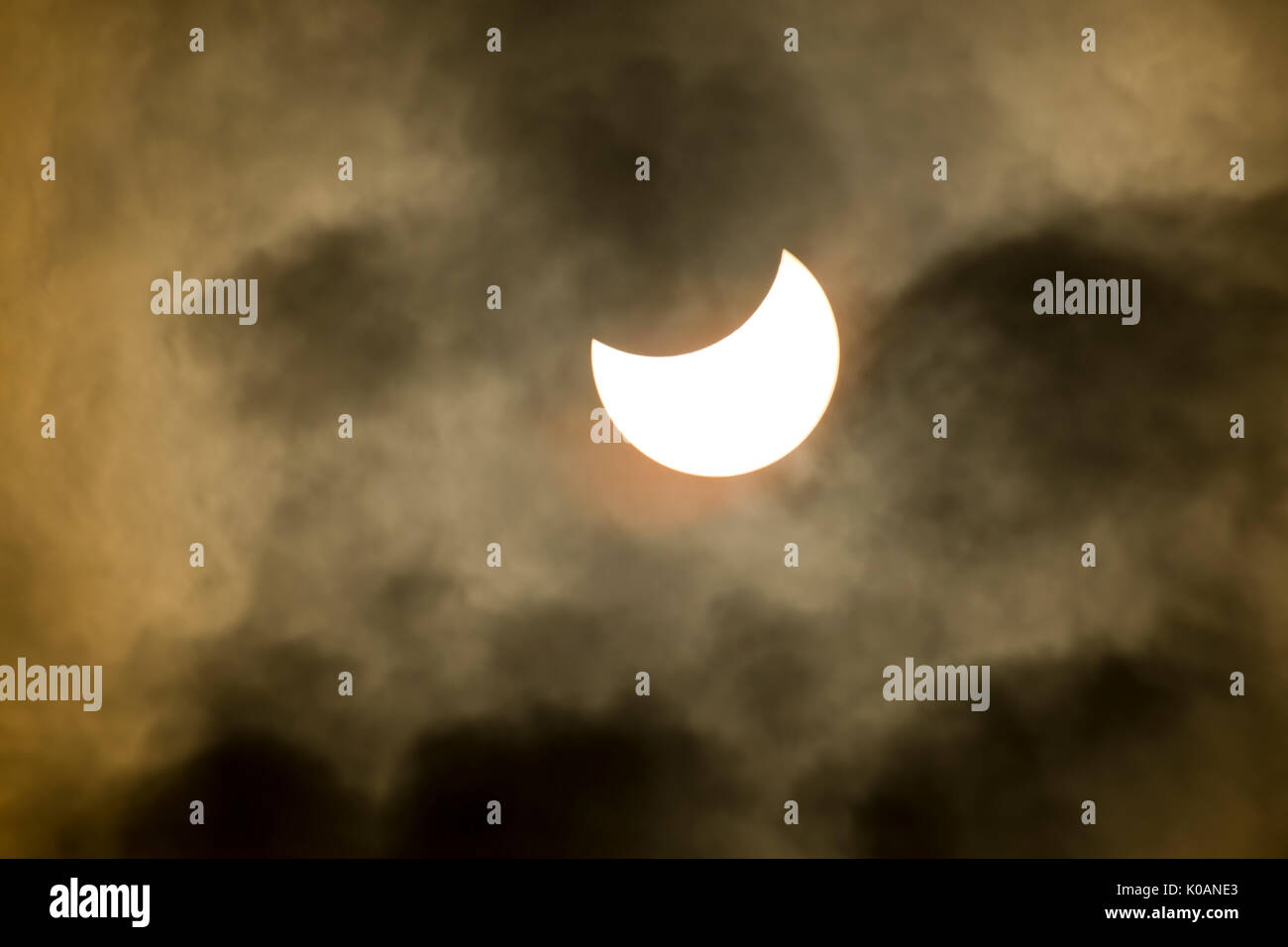Partial solar eclipse viewed under cloudy skies. Flagstaff, Arizona ...
