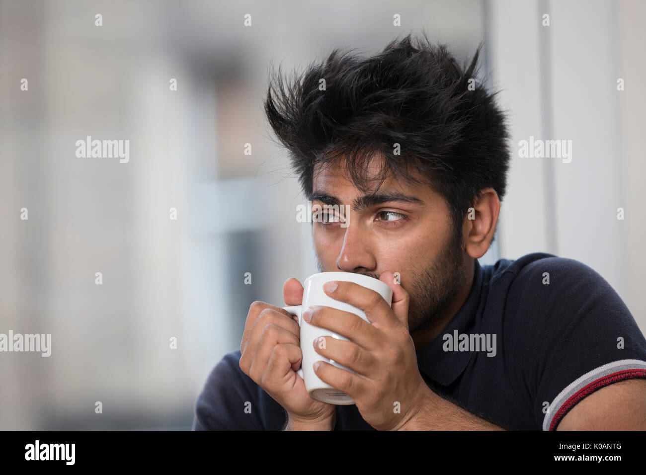 Young man mug tea thinking hi-res stock photography and images - Alamy