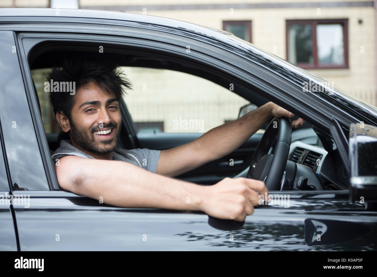 Portrait of a happy Indian man smiling in his new car Stock Photo - Alamy