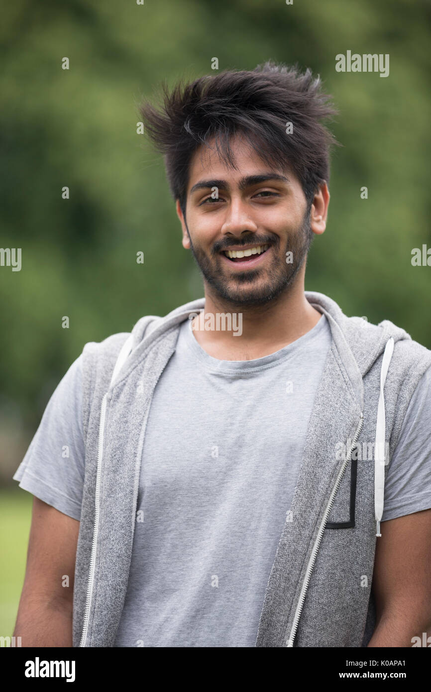 Happy indian man in jumper hi-res stock photography and images - Alamy