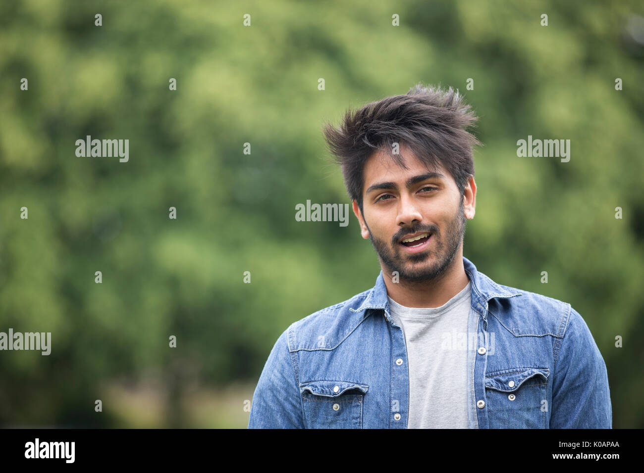 Happy indian man in jumper hi-res stock photography and images - Alamy