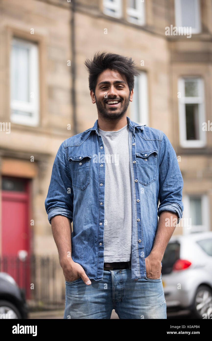 Portrait of a trendy Indian man standing in an urban man in street ...