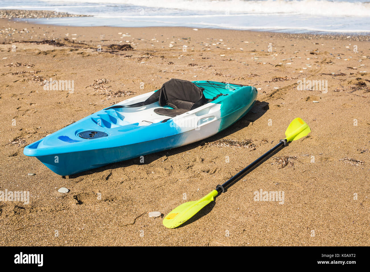 Concept of beach activity, water sport and kayaking. A bright blue ...