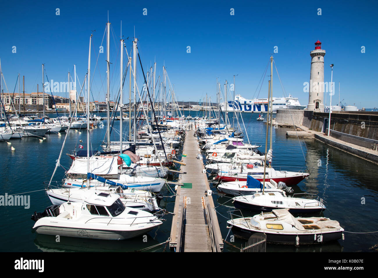Boats in the port of Sete, Southern France, with the Phare du Mole ...