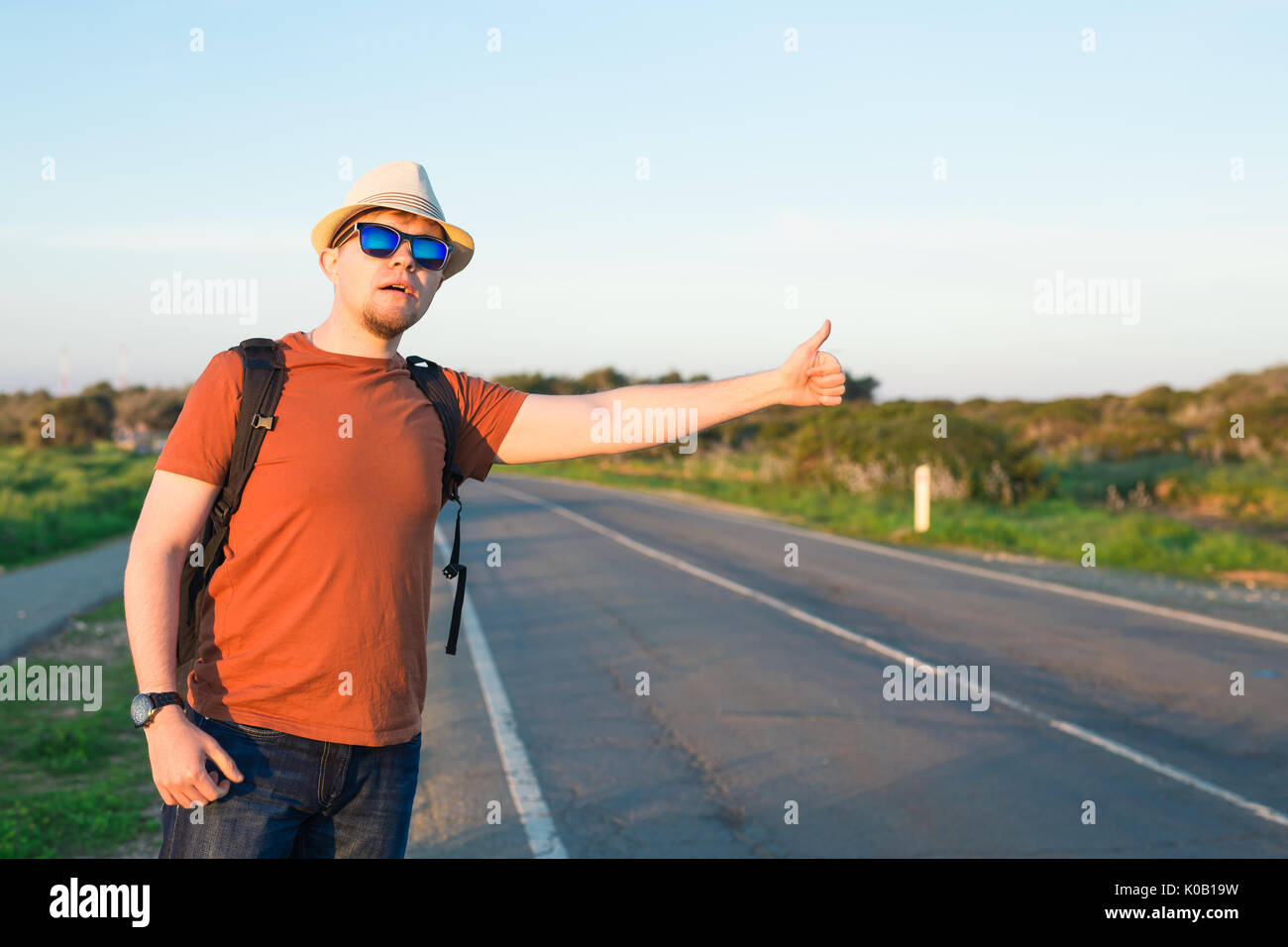 Man with Backpacks in casual Travel Clothes walking along road ,Road ...