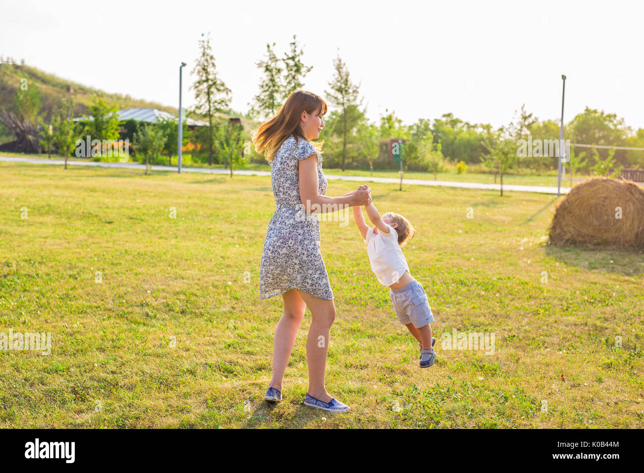 happy family having fun. baby boy and his mother playing outdoors Stock ...
