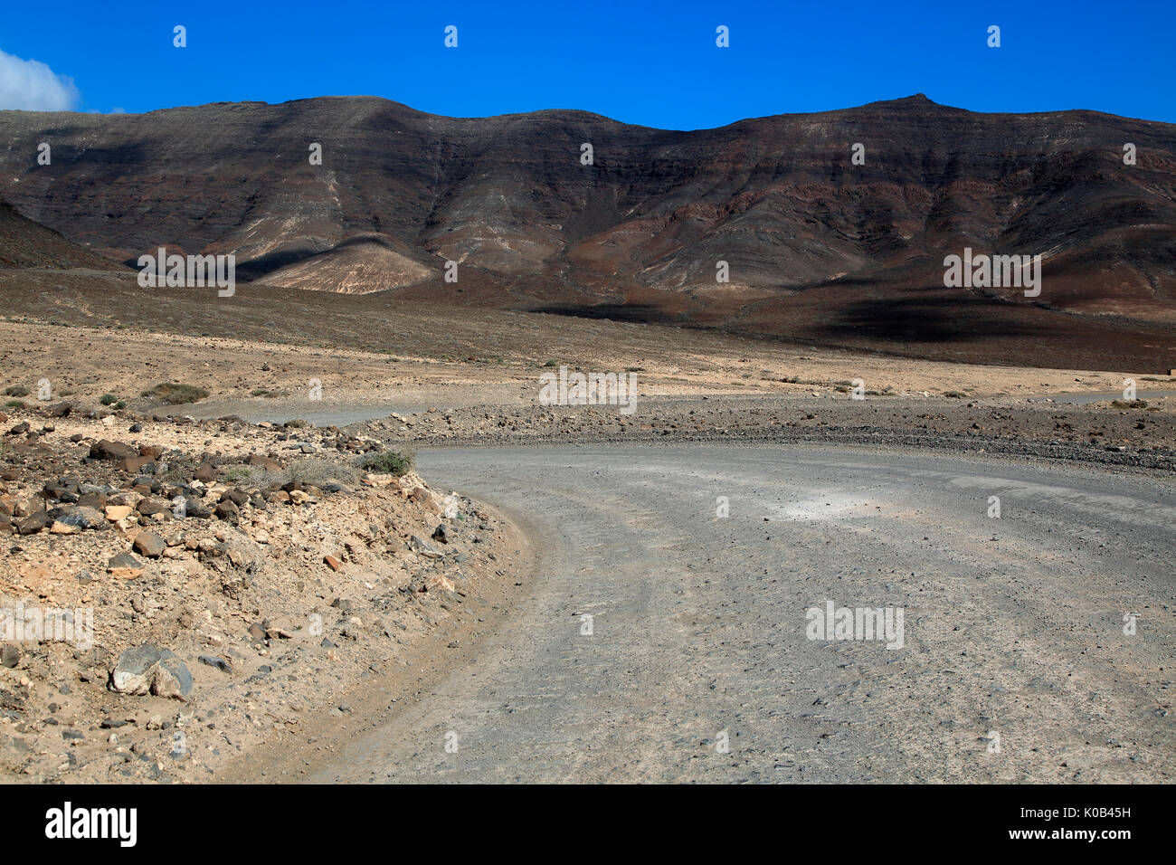 Unsurfaced road, barren rocky mountains, Jandia peninsula ...