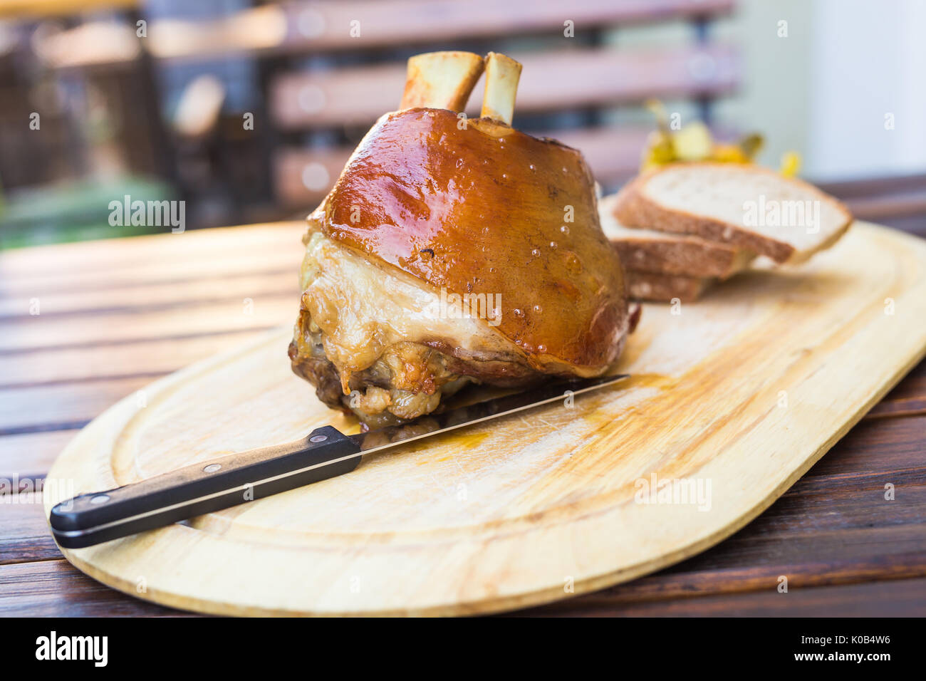 Roasted knuckle of pork on wooden board Stock Photo - Alamy