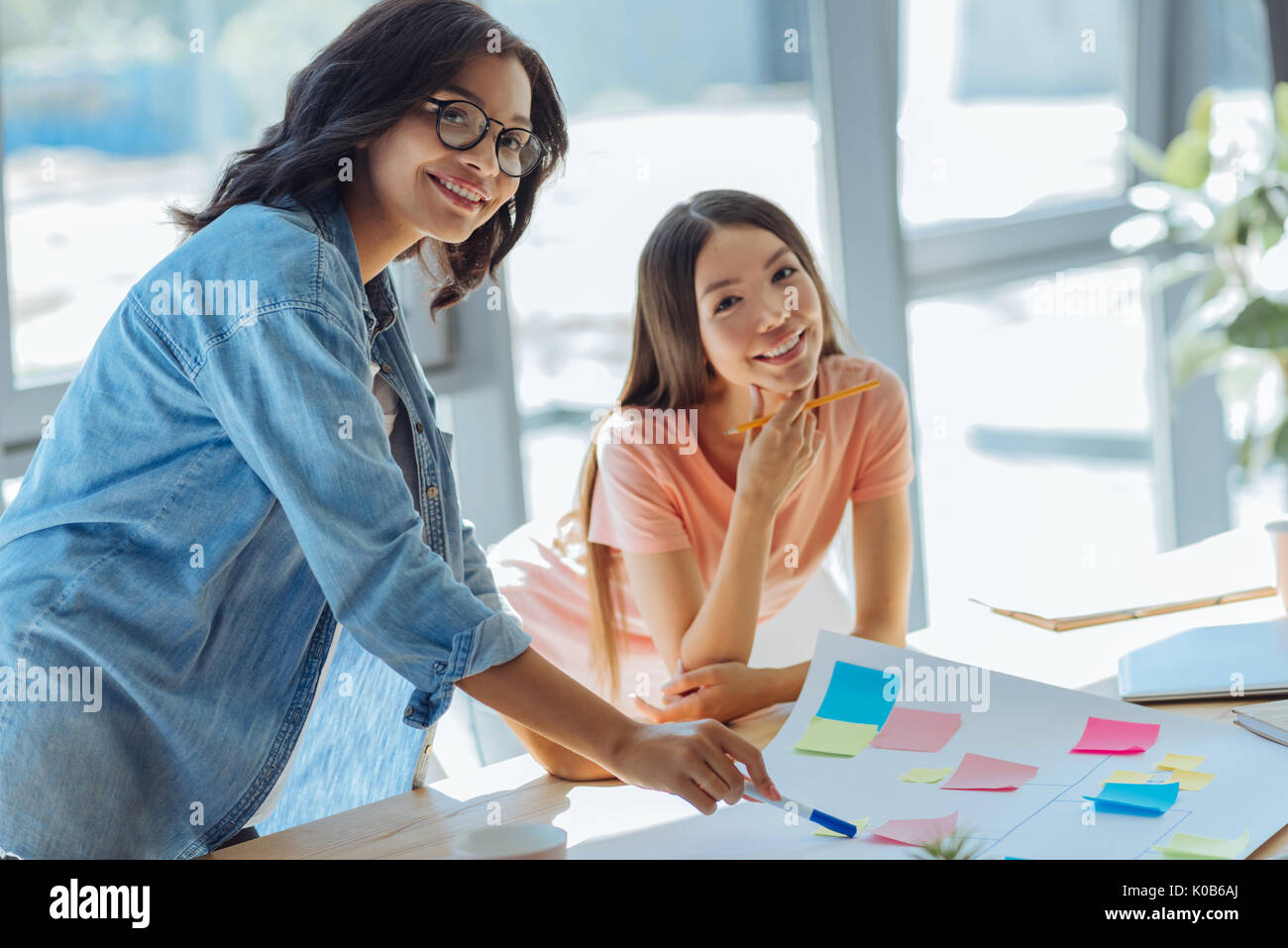 Pleasant beautiful women working in team Stock Photo - Alamy
