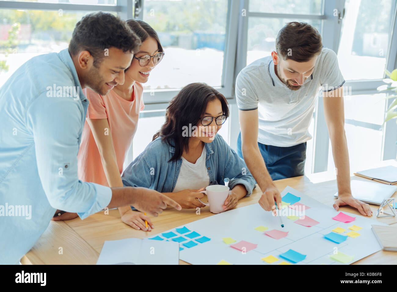 Positive smart man pointing at the poster Stock Photo - Alamy