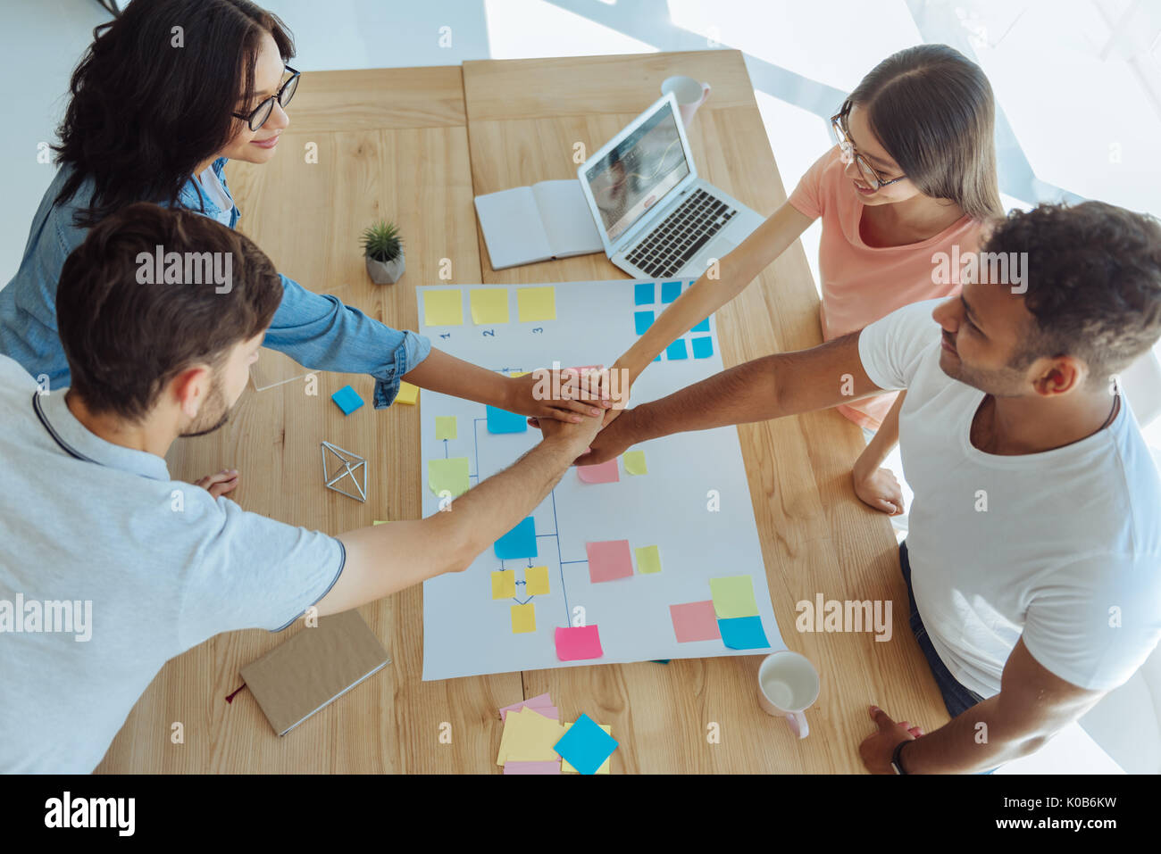 Delighted young people showing their unity Stock Photo - Alamy