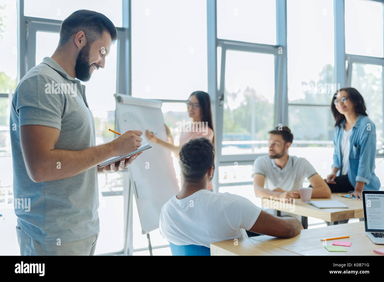 Smart positive man noting down information Stock Photo - Alamy