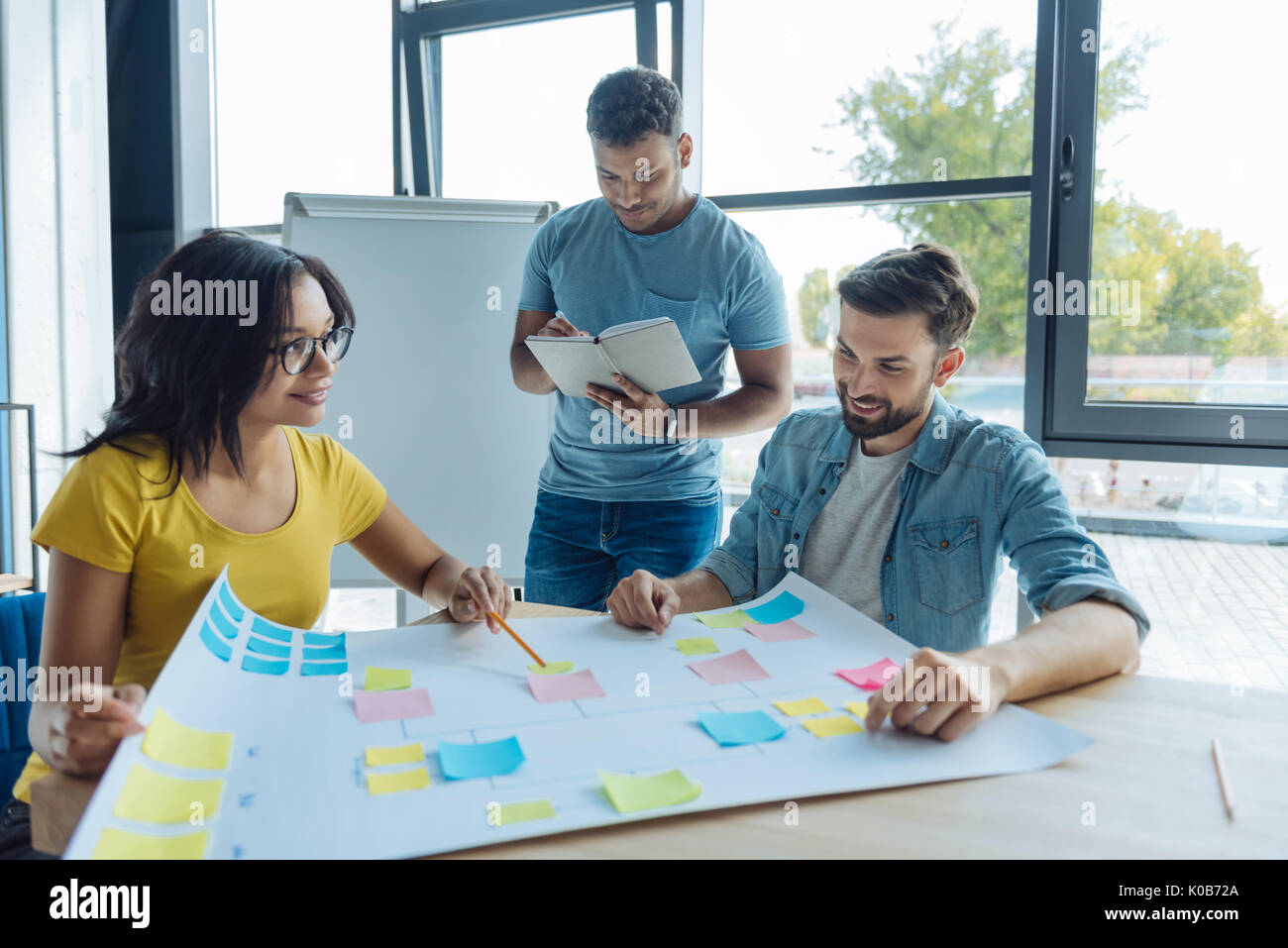 Positive nice colleagues talking to each other Stock Photo - Alamy