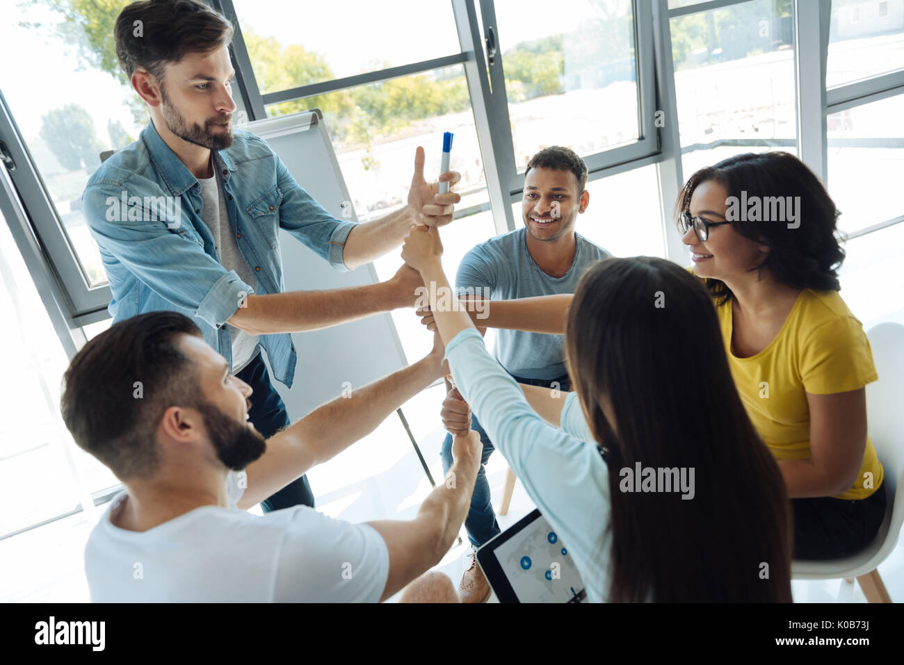Happy positive people holding hand together Stock Photo - Alamy