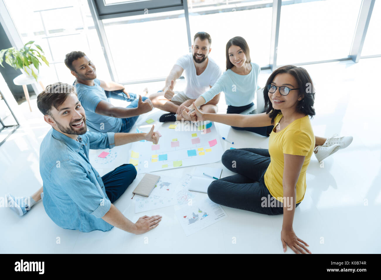 Happy young people showing thumb up gestures Stock Photo - Alamy