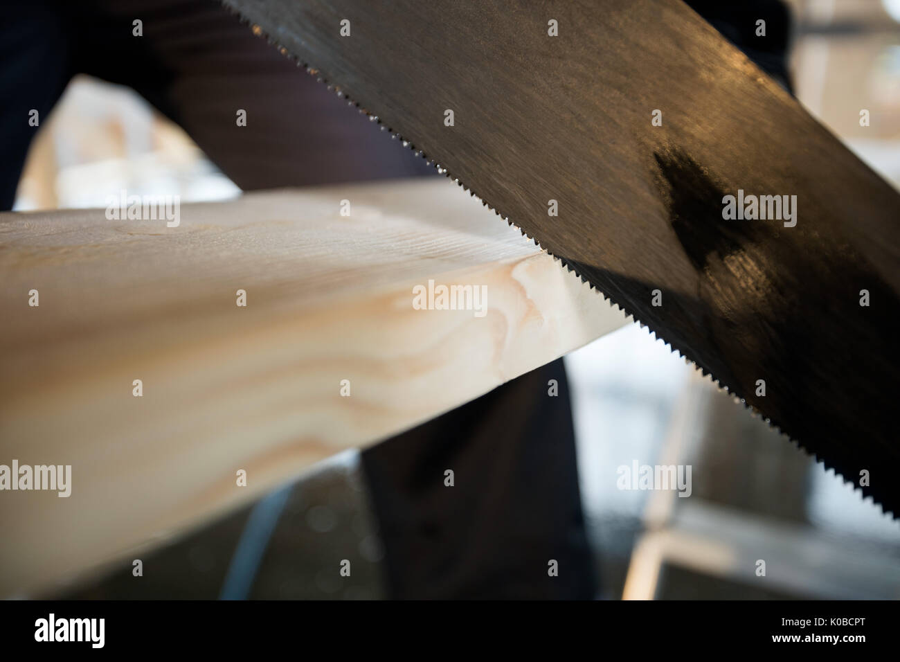 Hand Saw Cutting Wooden Plank At Site Stock Photo - Alamy