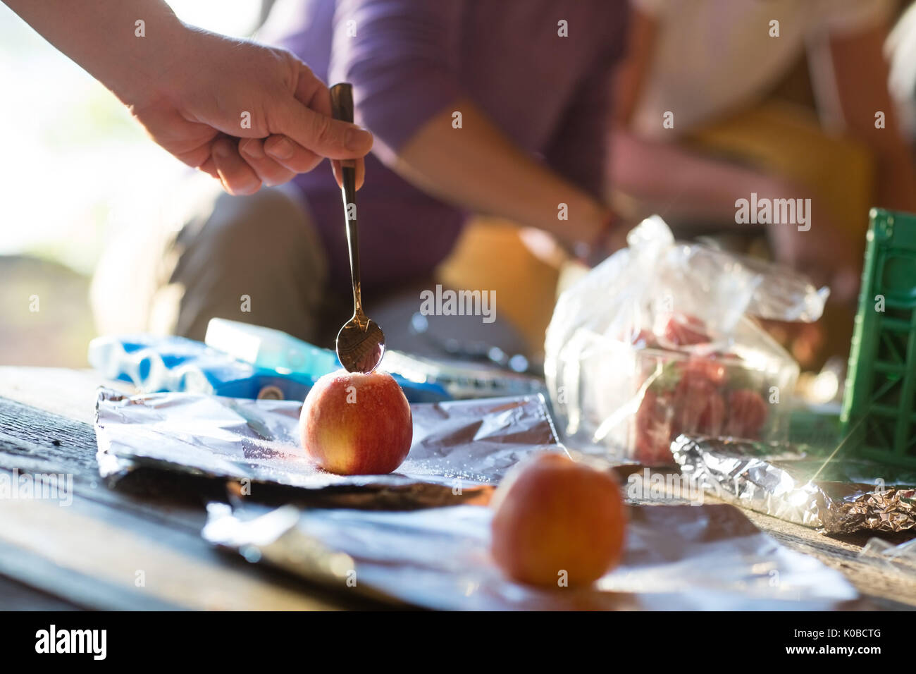 Hand Stuffing Chocolate Chips Into Apple In Shed Stock Photo - Alamy