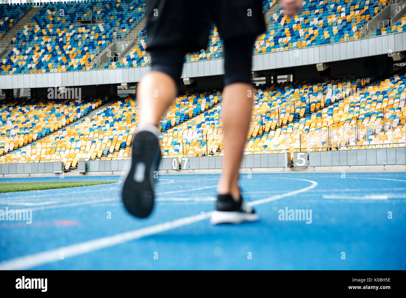 Close up of a male legs in sneakers on a recetrack at the stadium Stock ...
