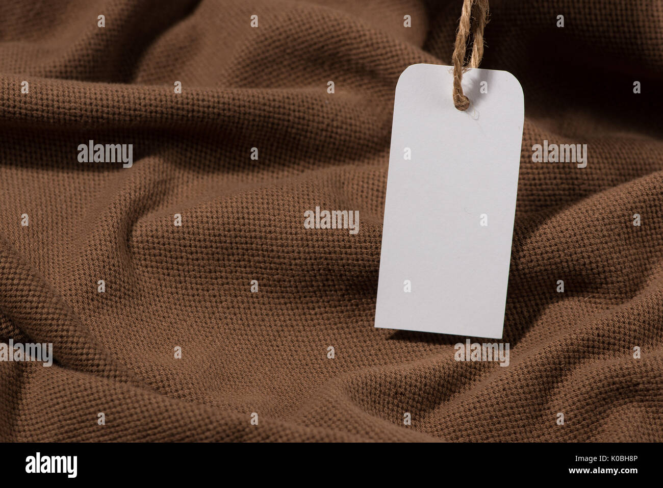 Shirt price tag. Rectangular tag is attached to a sweater Stock Photo ...
