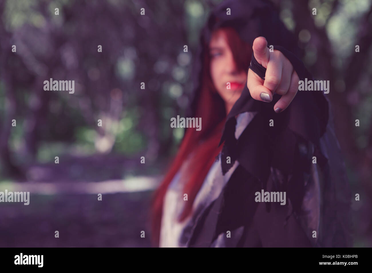 Image of young witch pointing finger at camera in forest Stock Photo ...