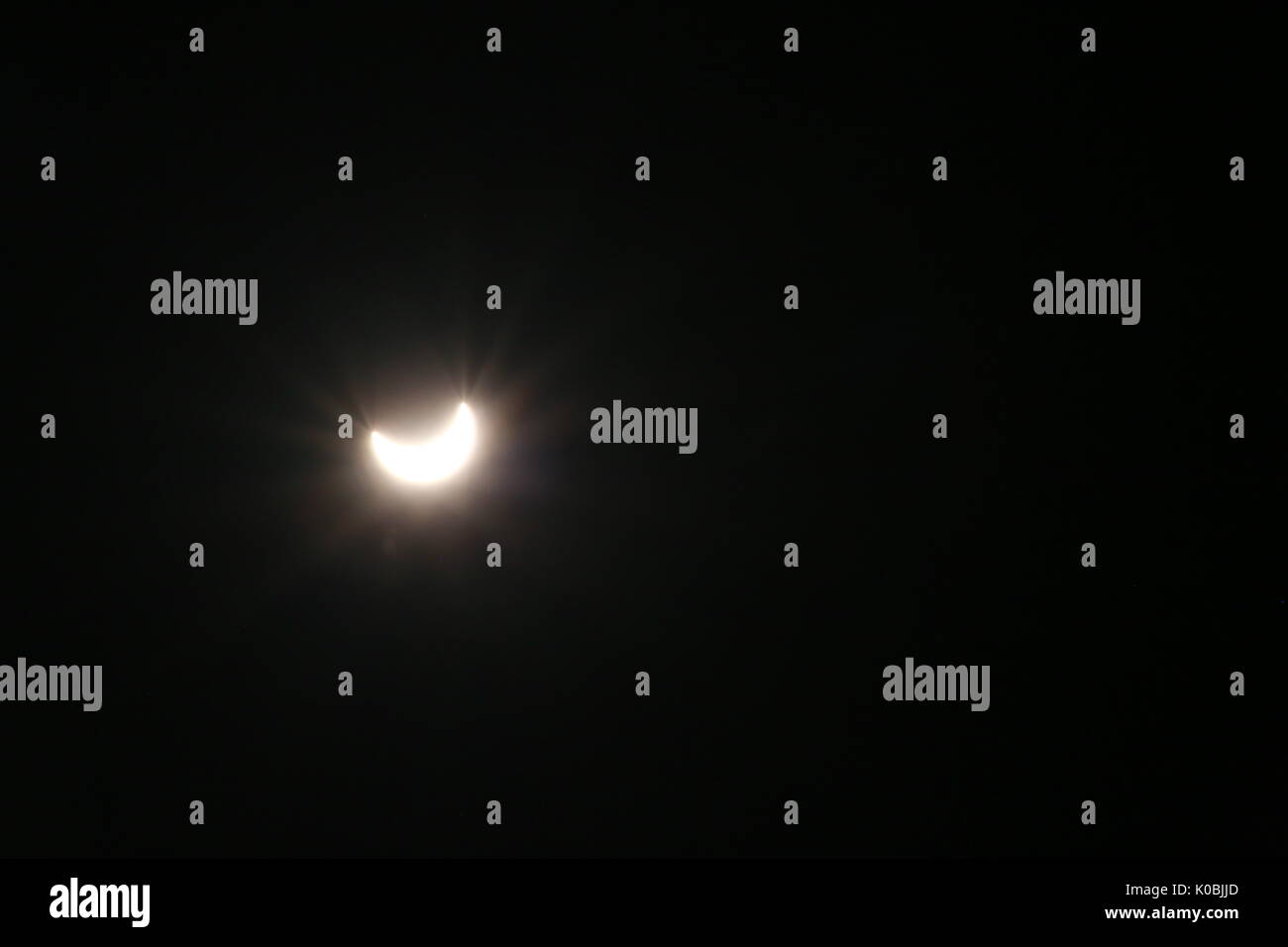 Crescent moon behind clouds hi-res stock photography and images - Alamy