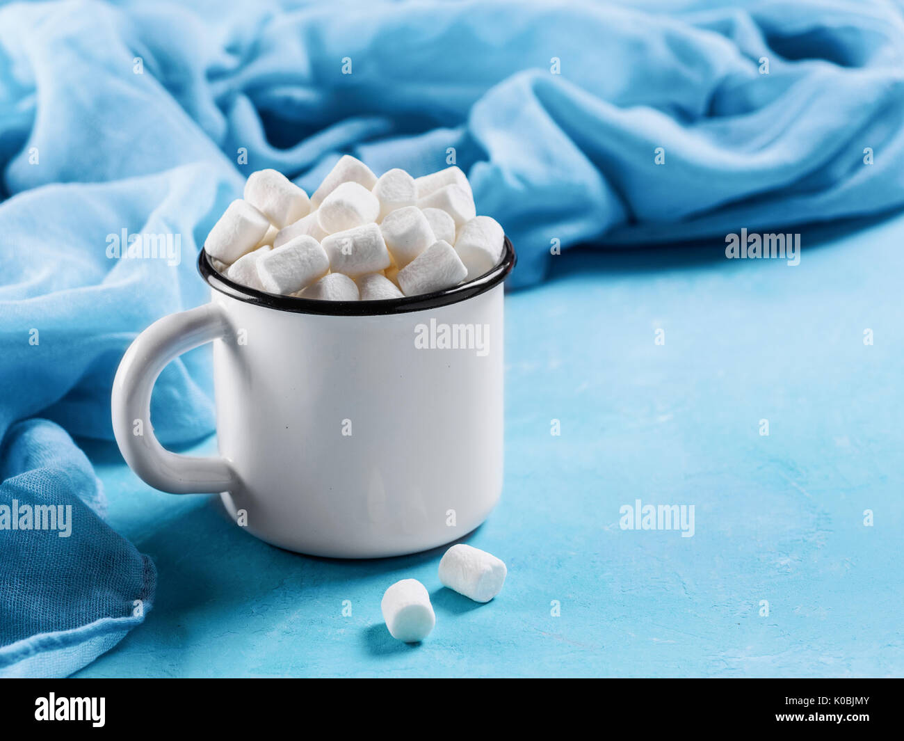 Marshmallows on blue background with copyspace Stock Photo - Alamy