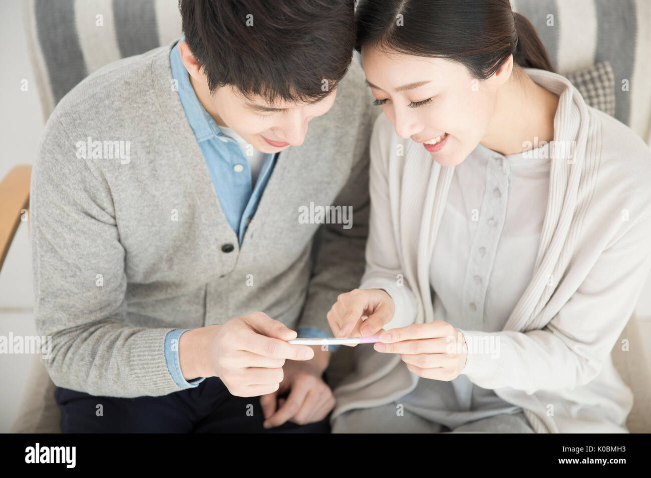 Harmonious couple doing pregnancy test Stock Photo - Alamy