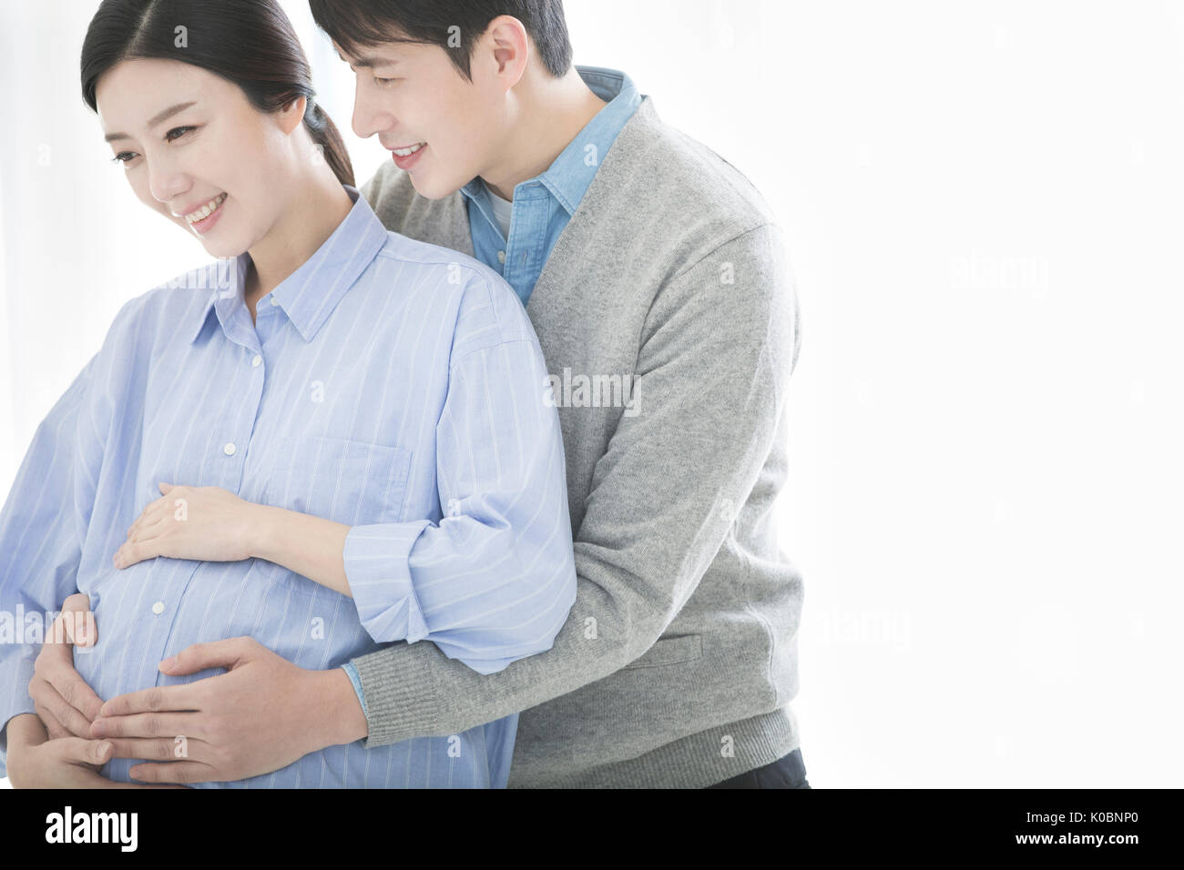 Portrait of harmonious pregnant couple hugging Stock Photo - Alamy