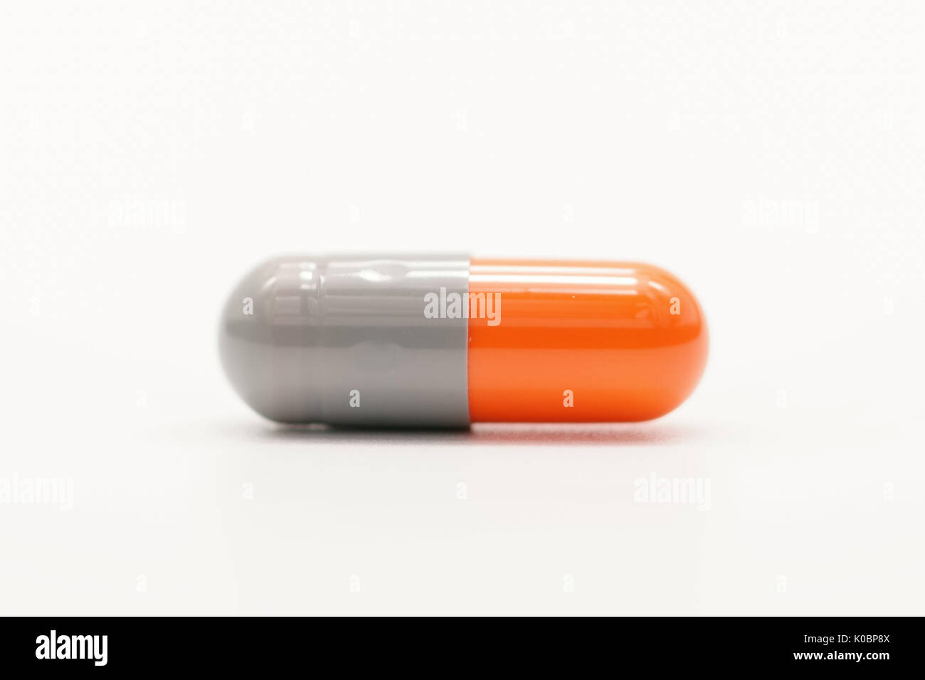 Grey, orange medicine capsule isolated on white background Stock Photo ...