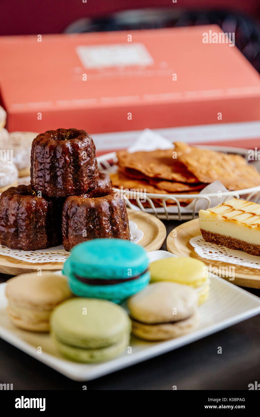 Canele chocolate and Macarons Stock Photo - Alamy