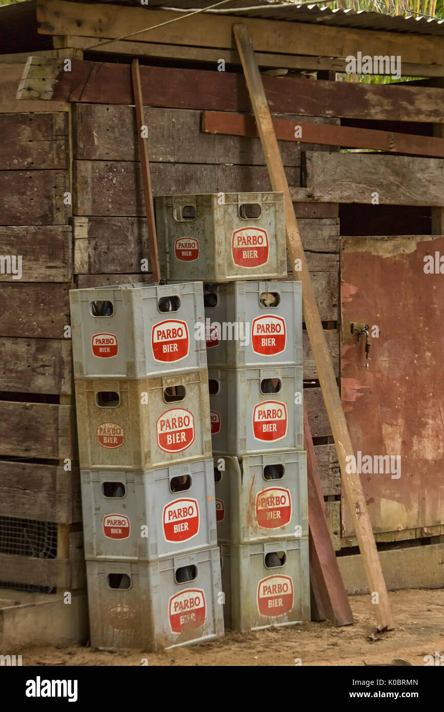Two stacks of Parbo beer crates near a wooden shed in Suriname, South ...
