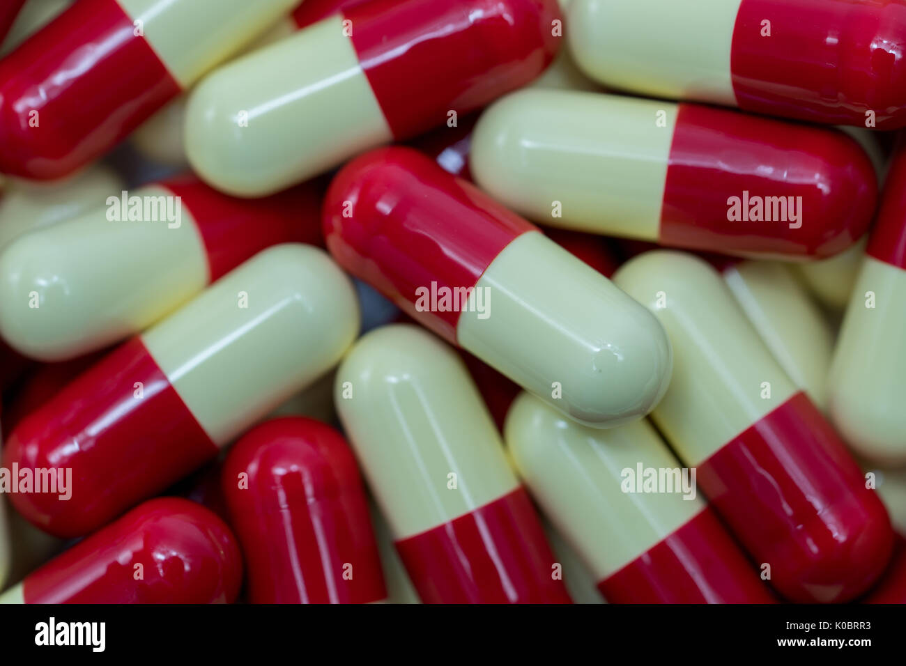 Top view of red, pale yellow, capsule pills Stock Photo - Alamy