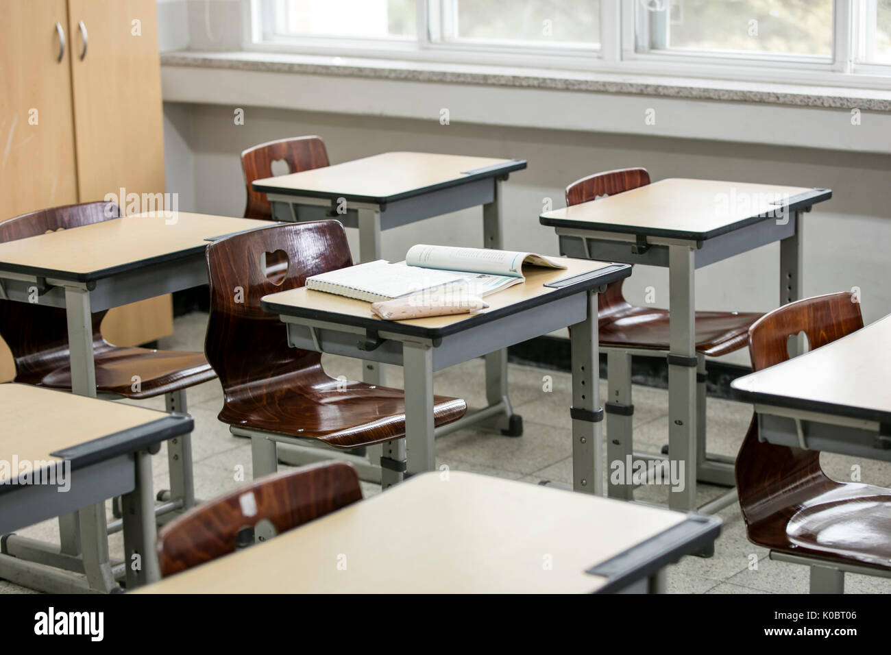 Desks and chairs in classroom Stock Photo - Alamy