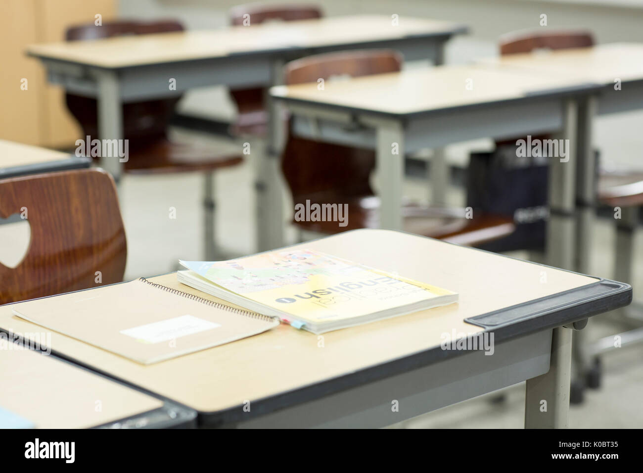 Notebook on a desk in classroom Stock Photo - Alamy